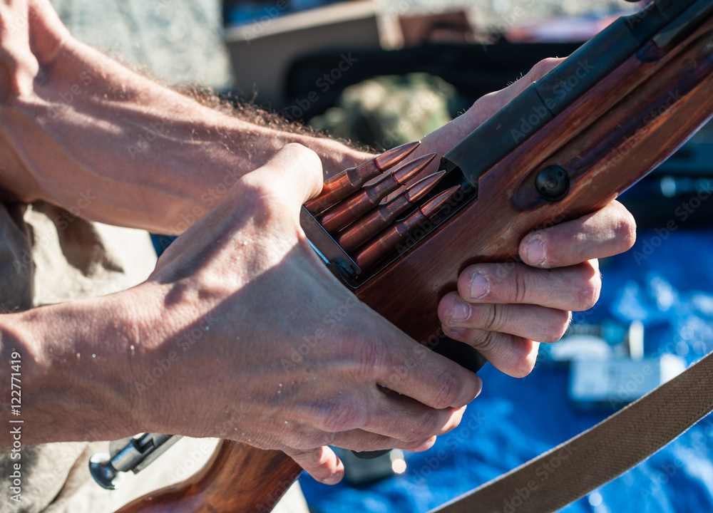Loading Ammunition into a world war two vintage soviet military rifle ...