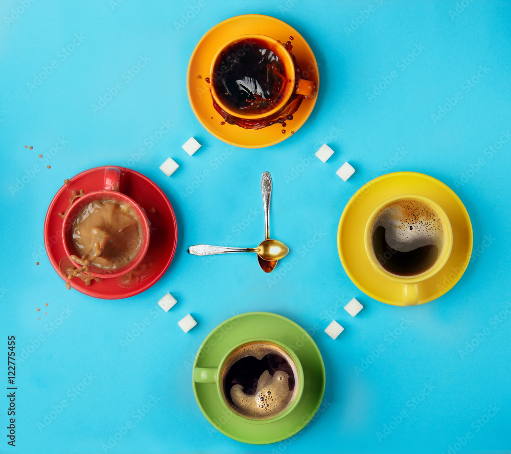 clock made with cups of coffee and teaspoon as lancets show nine o ...