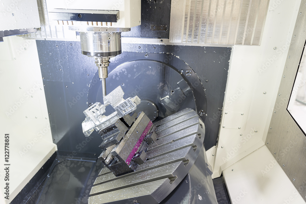 The 5-axis CNC machine while cutting the sample part of aircraft.The ...