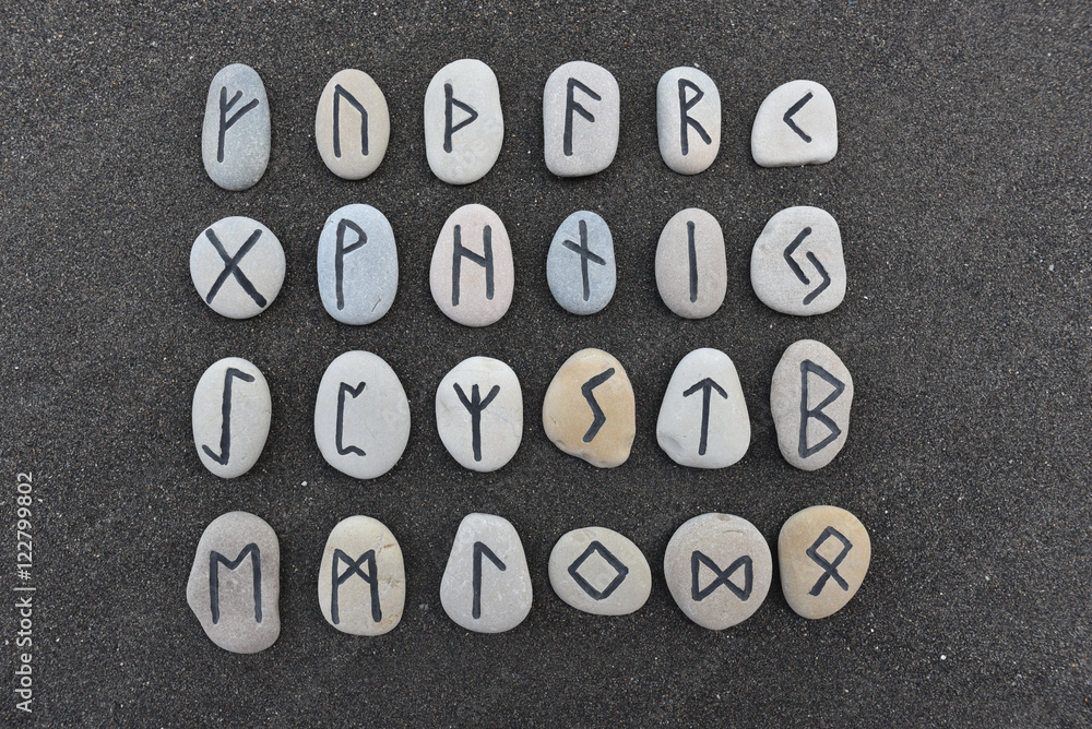Scandinavian runes sign, Futhark, Runic stones simbol on black volcanic ...