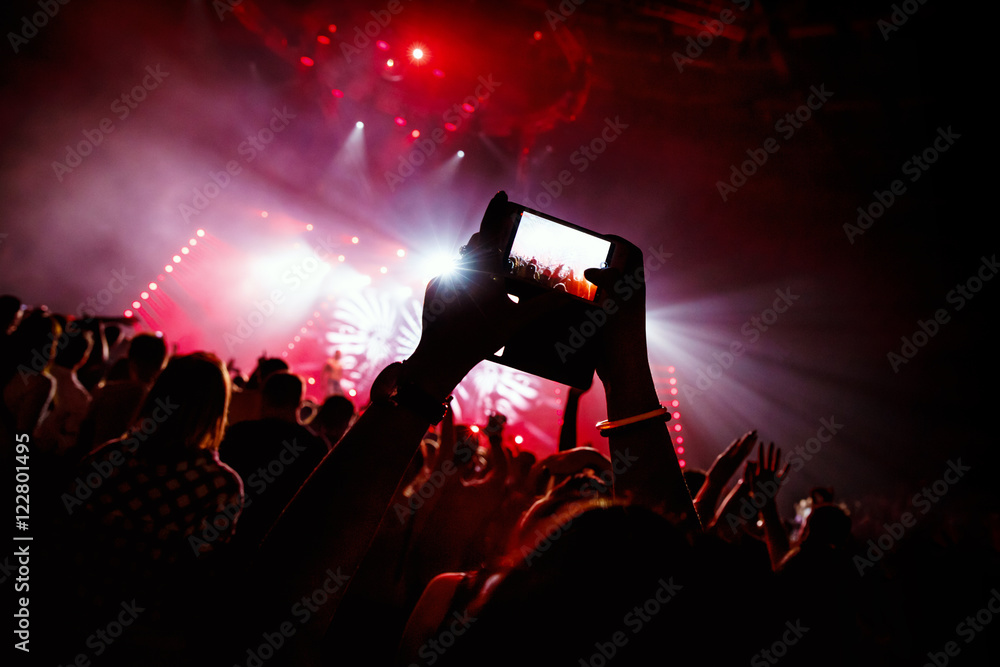 Hand with a smartphone records live music festival, Taking photo of ...