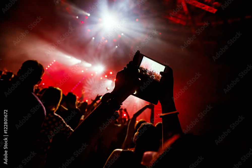 Hand with a smartphone records live music festival, Taking photo of ...