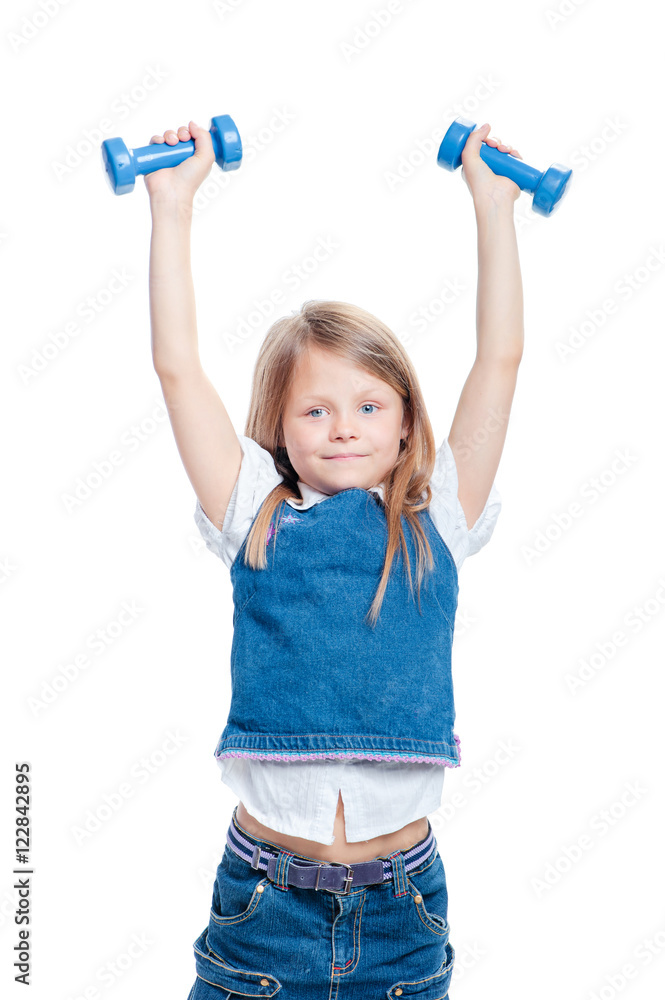 Super strong kid. Pretty little girl raised up dumbbells. Isolated on ...