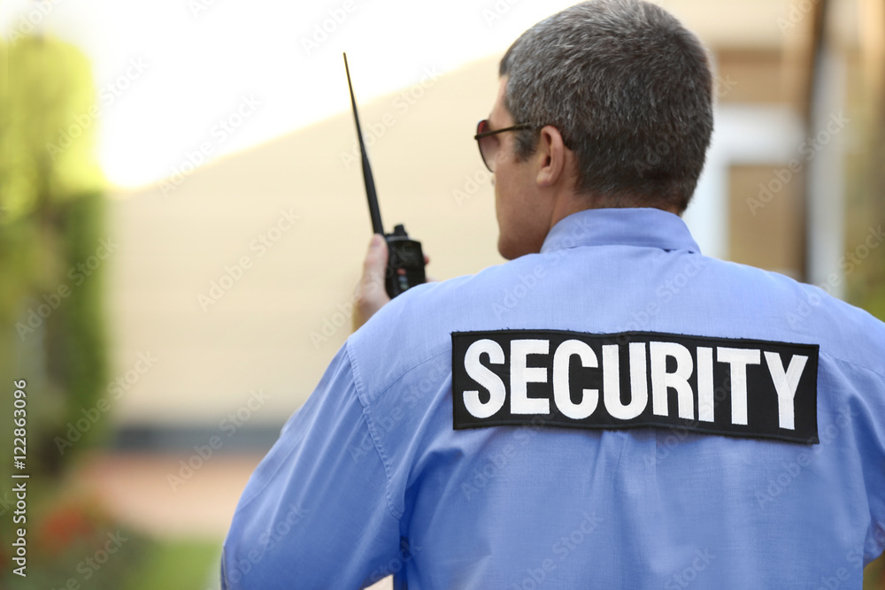 Male security guard protecting house outdoor Stock Photo | Adobe Stock