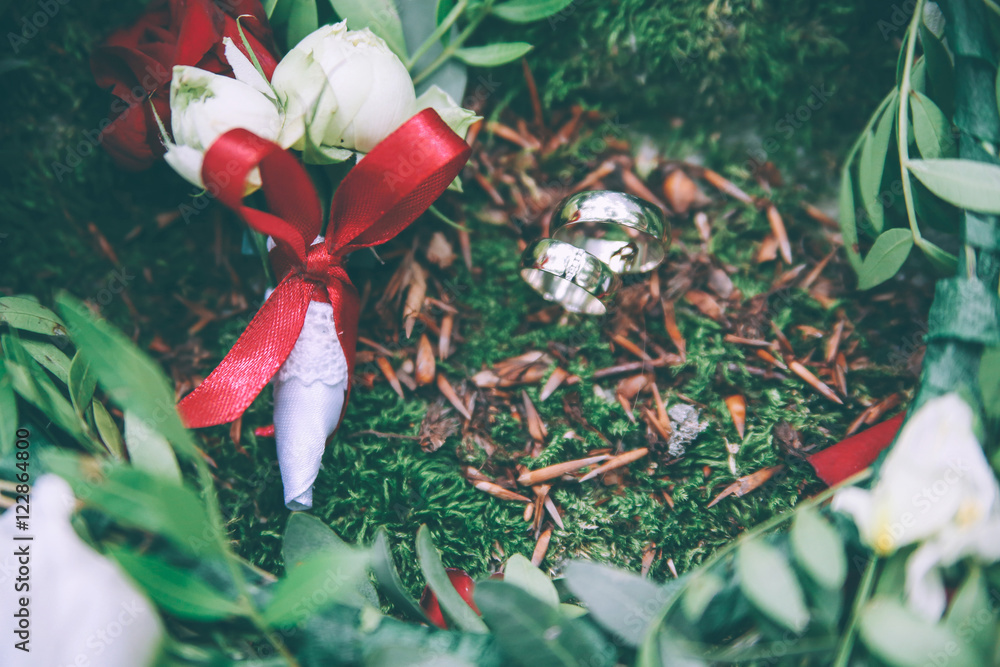 wedding rings at green background Stock Photo | Adobe Stock