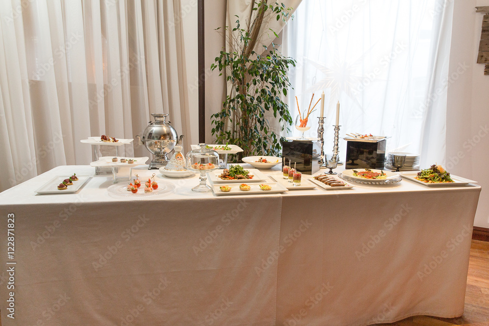 Rich table with appetizers stand behind a huge window Stock Photo ...