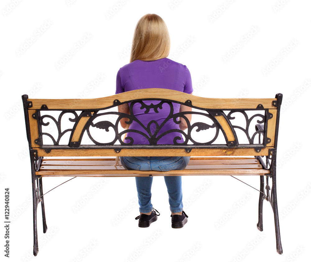 Back view of a woman sitting on a bench. girl watching. Rear view ...