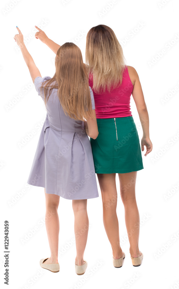 Back view of two pointing young girl. Rear view people collection ...
