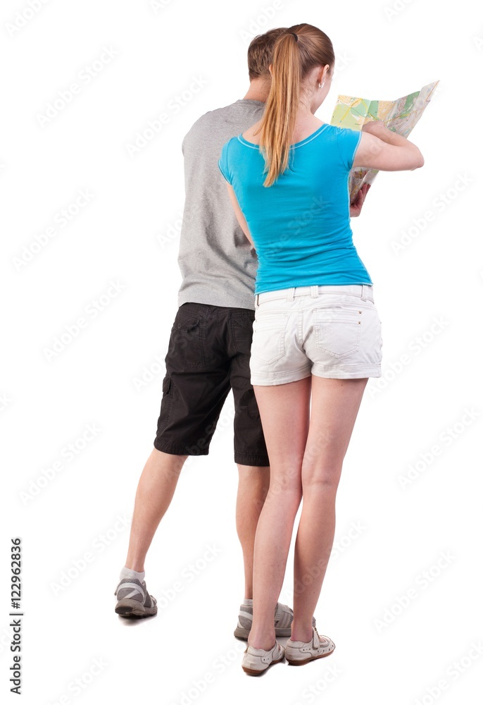 Back view journey of the young couple looking at the map. Rear view ...