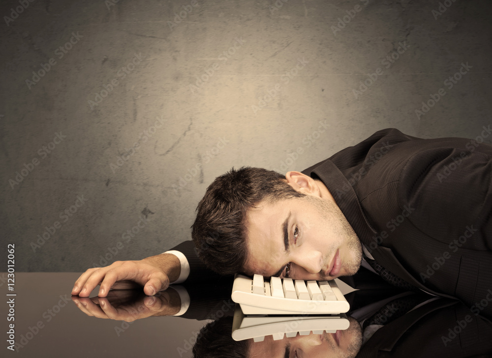 Frustrated businessman's head on keyboard Stock Photo | Adobe Stock