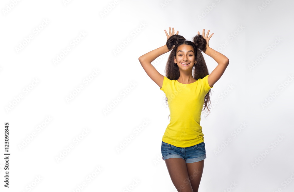 Emotional young brunette girl with long hair in yellow shirt on a white ...