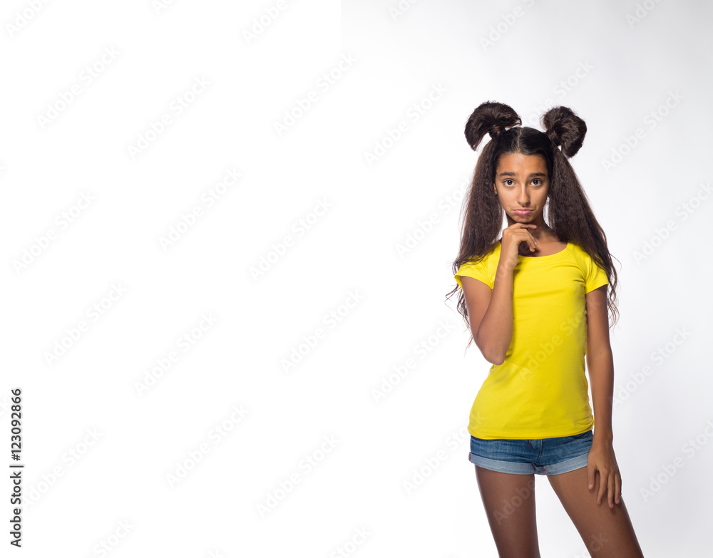 Emotional young brunette girl with long hair in yellow shirt on a white ...