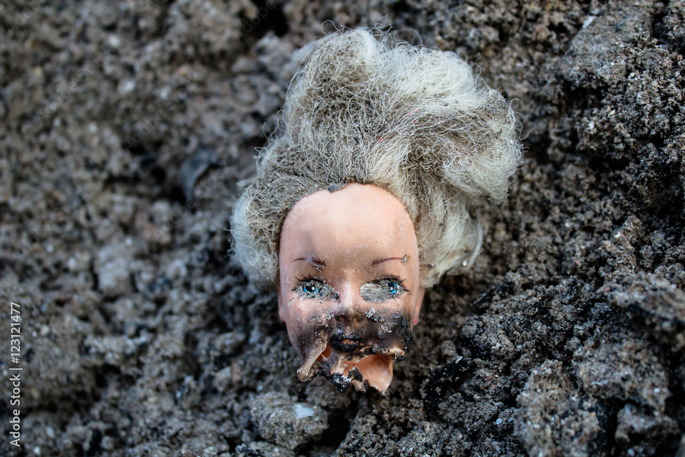 Melted plastic girl doll head lie in a pile of ash Stock Photo | Adobe ...