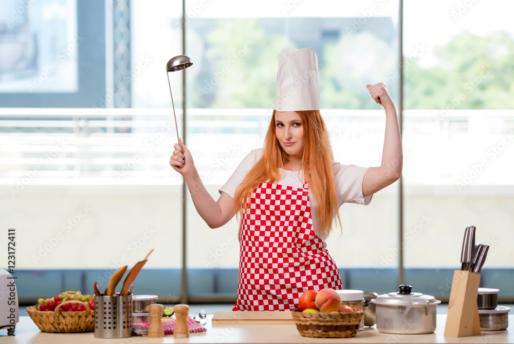 Redhead cook working in the kitchen Stock Photo | Adobe Stock