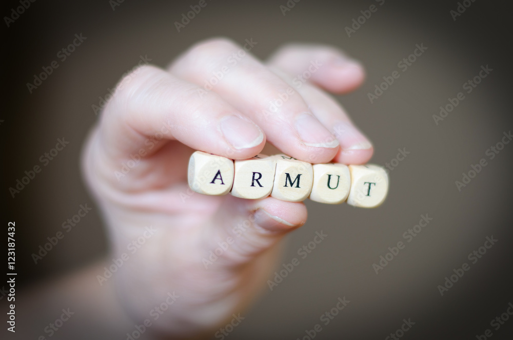 Armut, arm, kein Geld, Buchstabenwürfel zwischen den Fingern ...