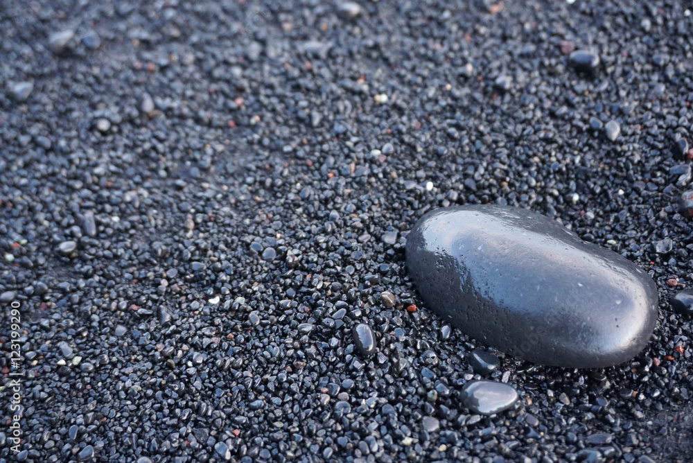 Black shinny rock on the rock beach Stock Photo | Adobe Stock