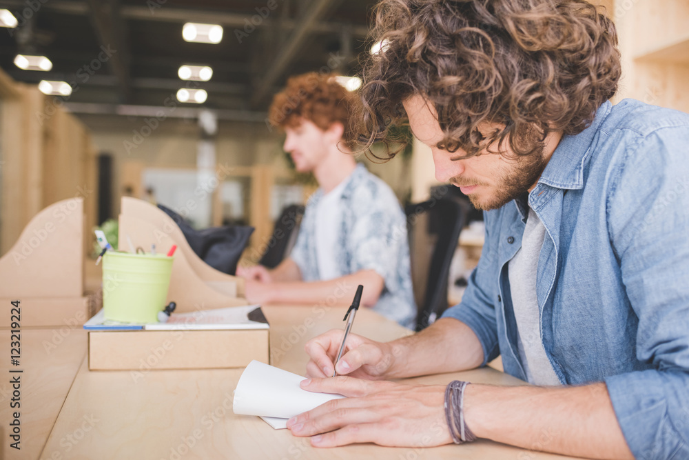Co-workers working in open plan office Stock Photo | Adobe Stock