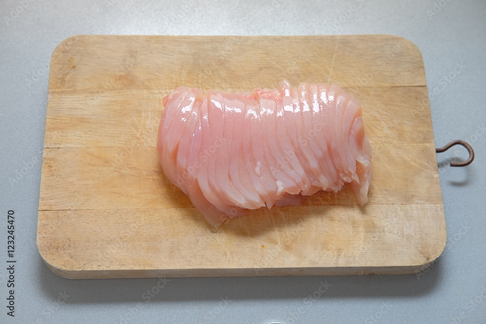 Raw chicken breast without skin on on the kitchen wooden board. foto de ...