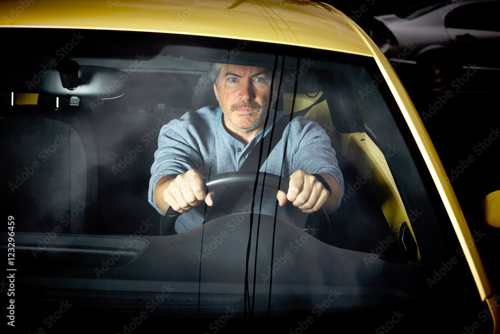 Tired man driving car at night. foto de Stock | Adobe Stock
