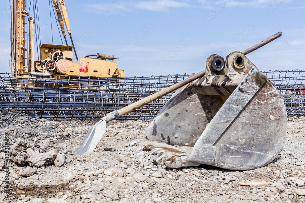 Excavator's bucket and shovel in front of skeleton reinforcing s Stock ...