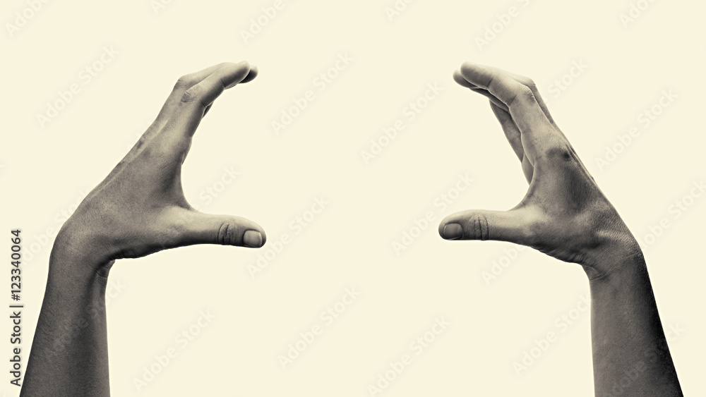 Two hands hold your object. This toned, black and white image is ...