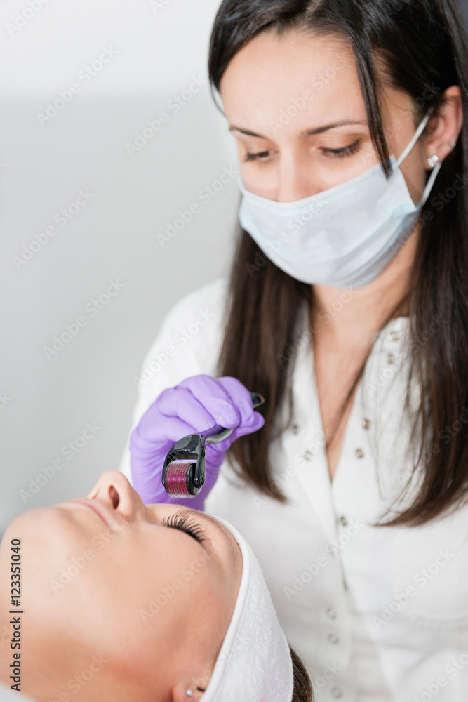 Dermatologist using dermal roller Stock Photo | Adobe Stock