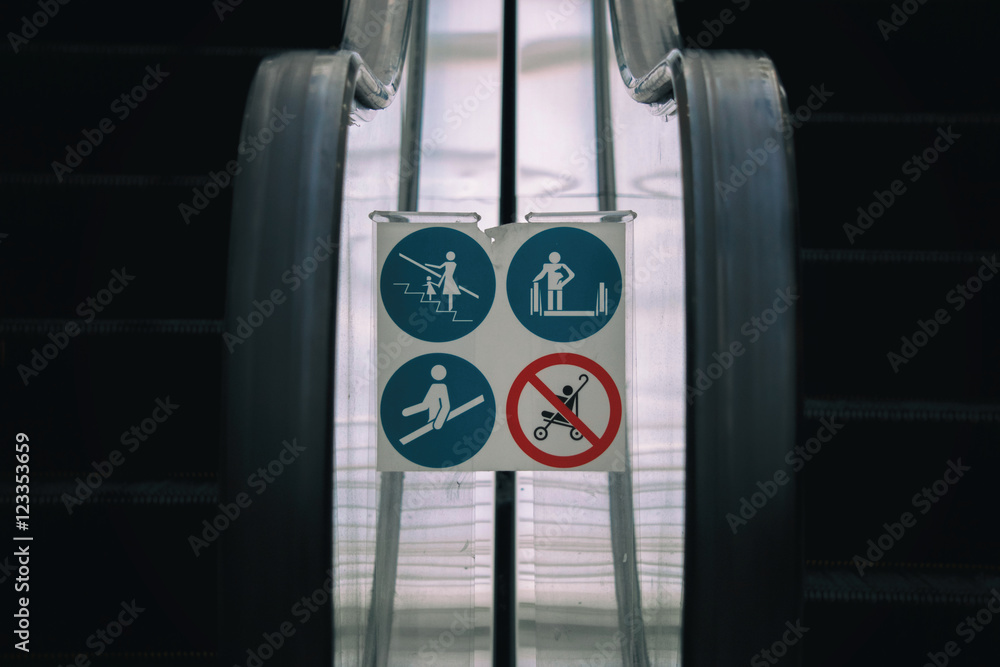 signs on an escalator, warning signs, the escalator at the mall Stock ...