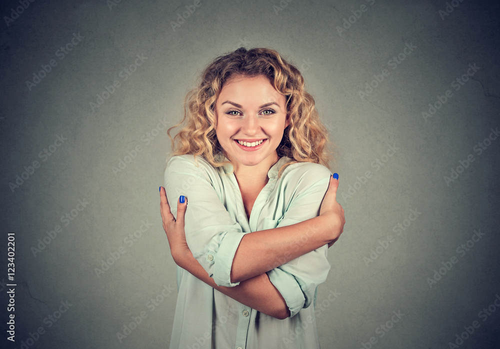 Smiling woman holding hugging herself. Love yourself concept Stock ...