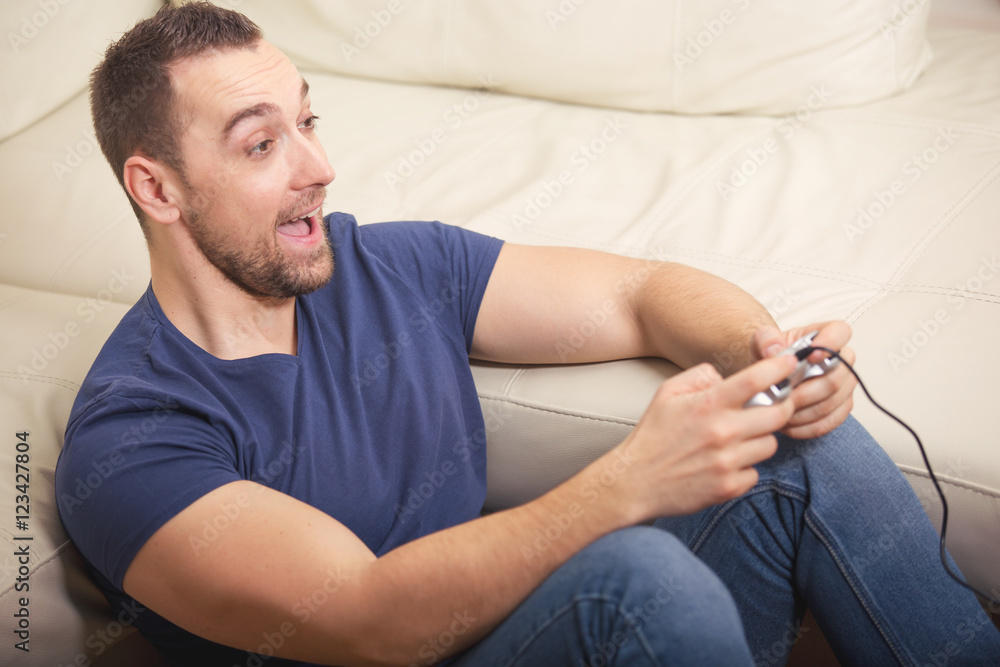 Young guy enjoying computer game, playing with joystick, smiling Stock ...