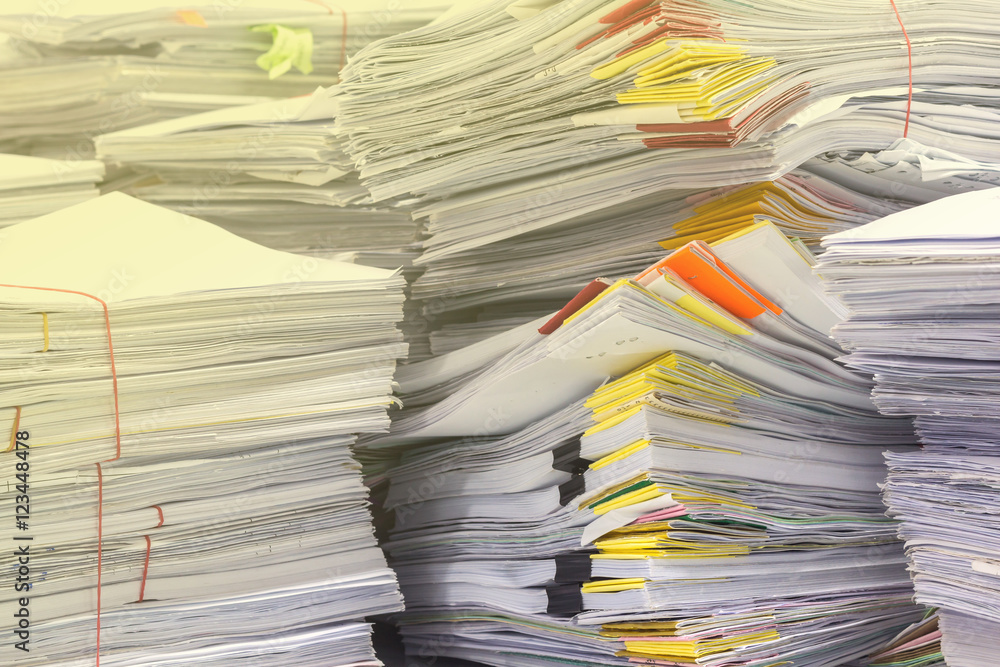Pile of documents on desk stack up high waiting to be managed Stock ...