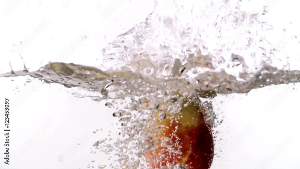 Tropical fruits falling into water on white background slow motion HD ...