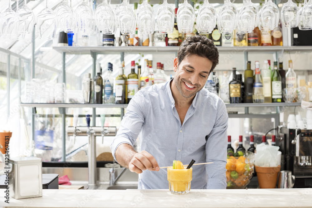 Happy bartender preparing cocktail at restaurant foto de Stock | Adobe ...