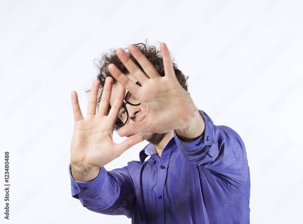Young man shielding face his hands Stock Photo | Adobe Stock