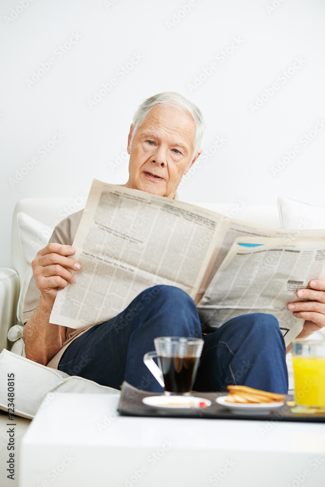 Old man reading a newspaper Stock Photo | Adobe Stock