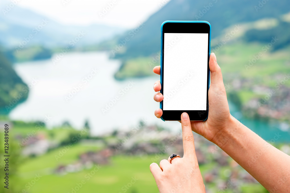 Phone with white screen to copy paste on the landscape background in ...