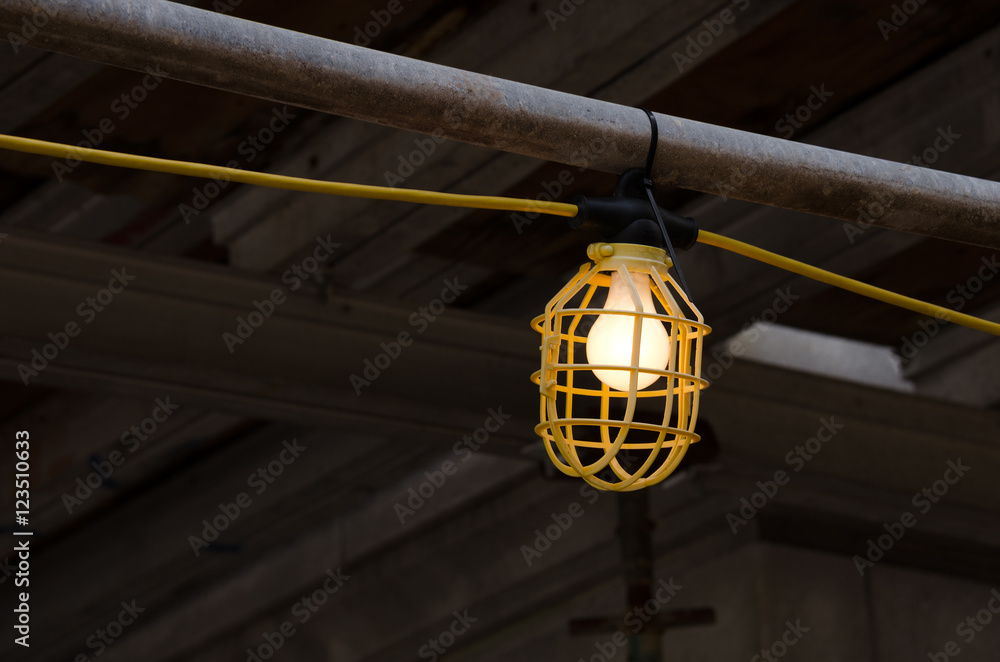 Yellow plastic lamp guard cage with yellow electrical wire lit electric ...