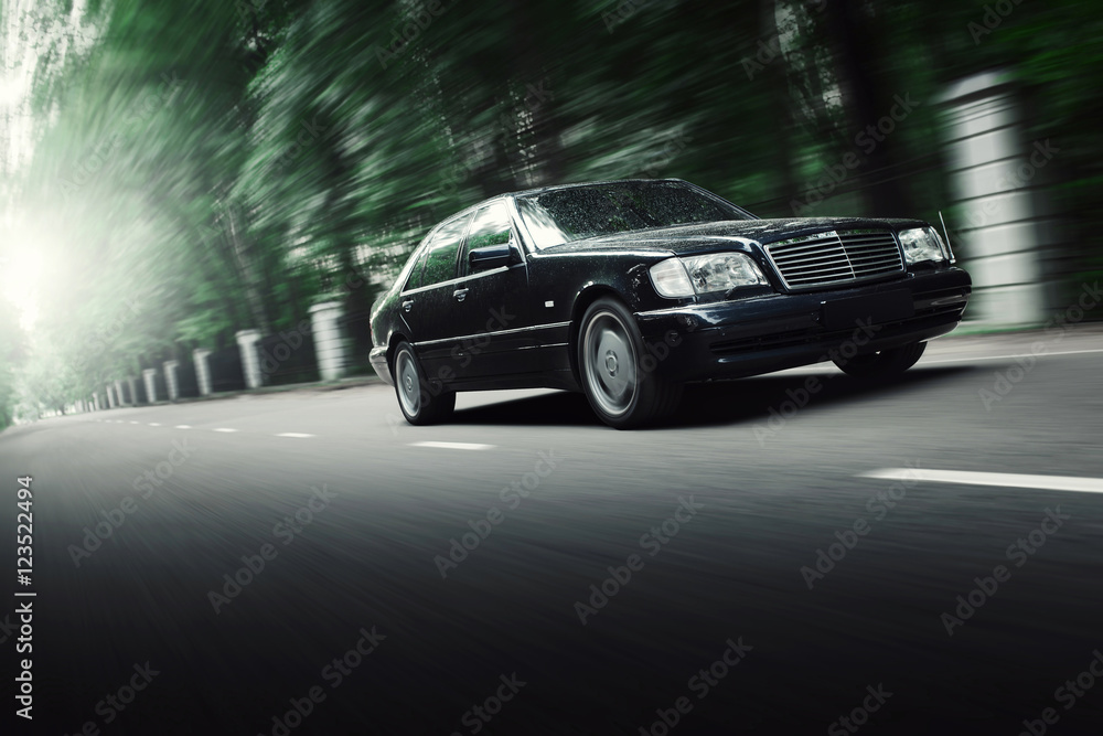 Black car drive on asphalt road in nature park of city at daytime Stock ...