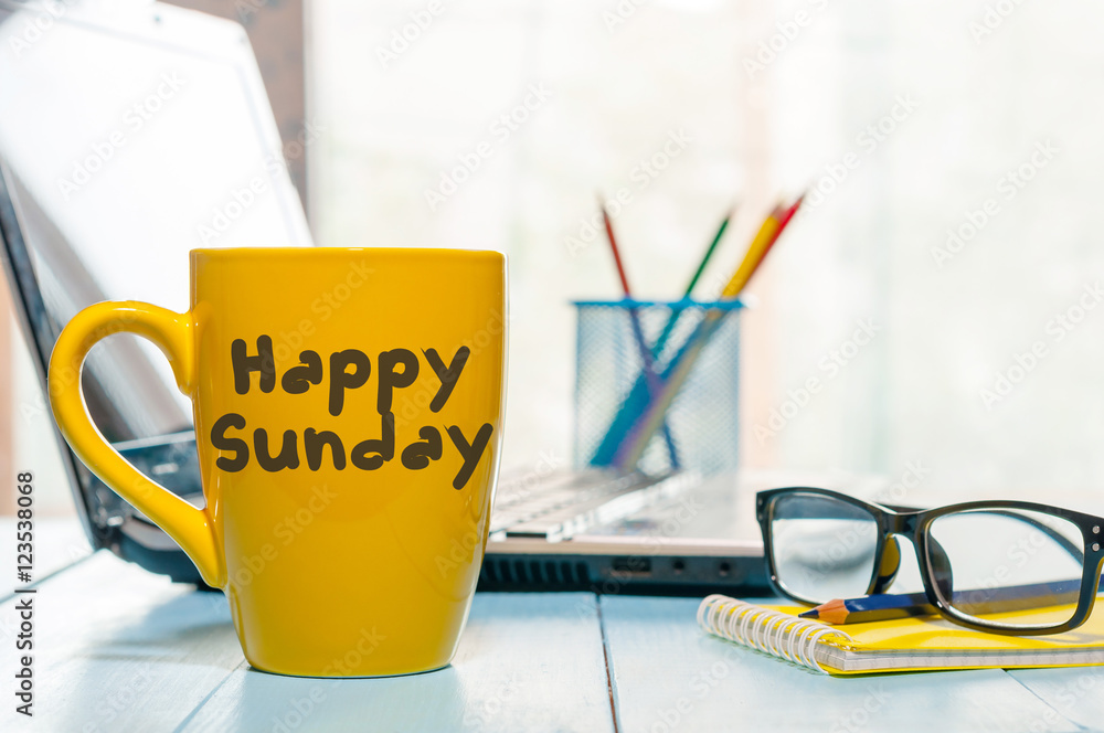 Happy Sunday word on table with computer. At work and self-education, e ...