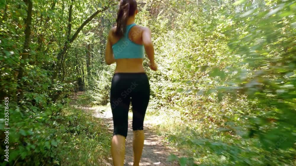 Tracking camera of woman girl running jogging in park, wood, forest ...