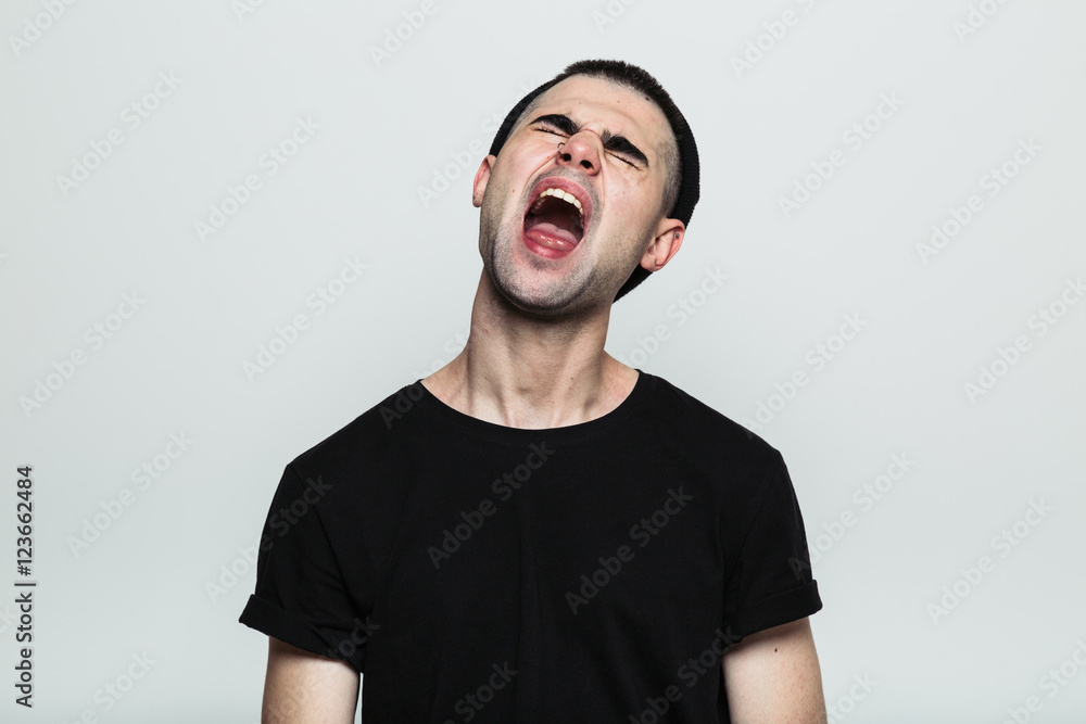 Studio shot of an annoyed man screaming, his head tilted back Stock ...