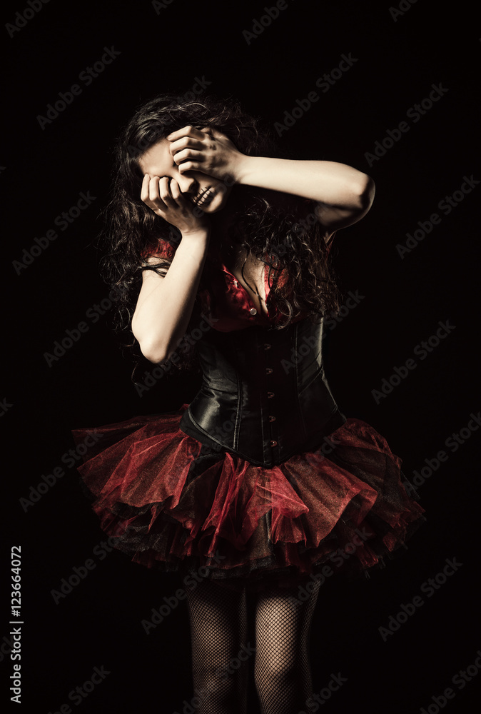 Horror shot: strange crying girl with mouth sewn shut among the dark ...