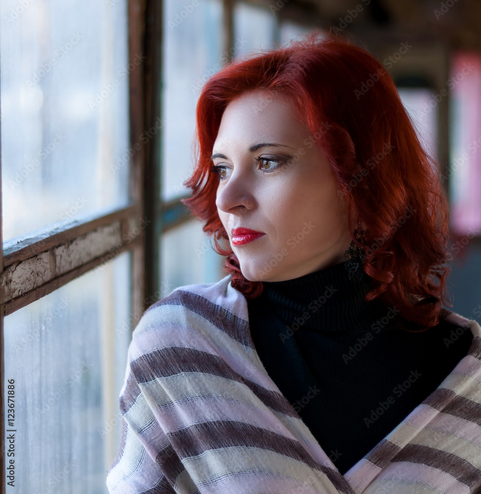 Sad young red-haired girl, a sad girl look with a scarf. Dramatic photo ...