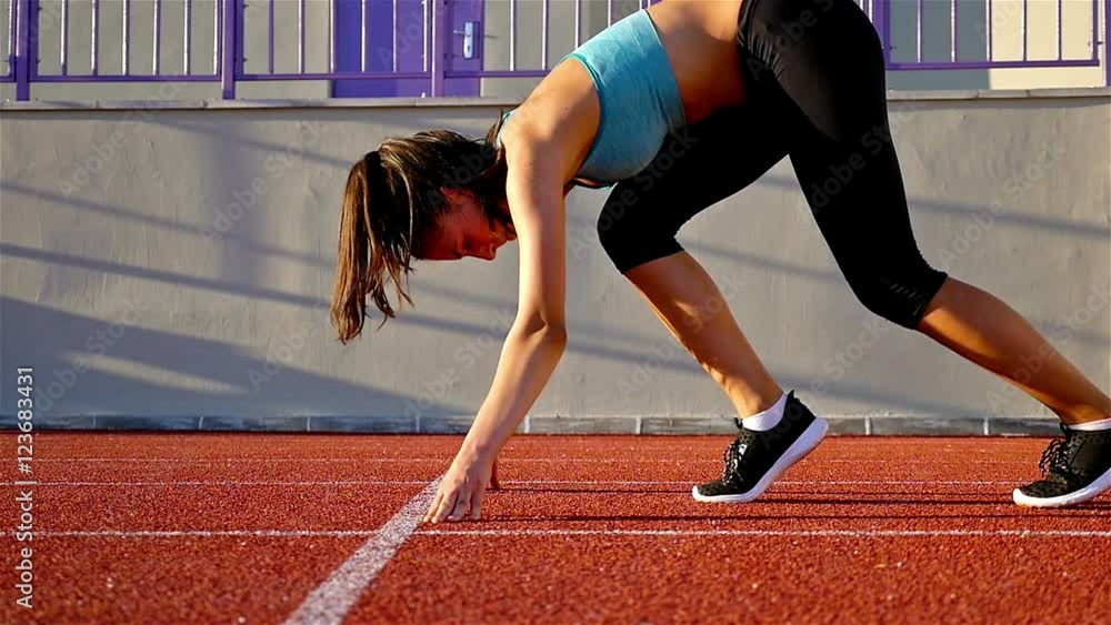 Track runner woman preparing to run at starting line, slow motion Stock ...