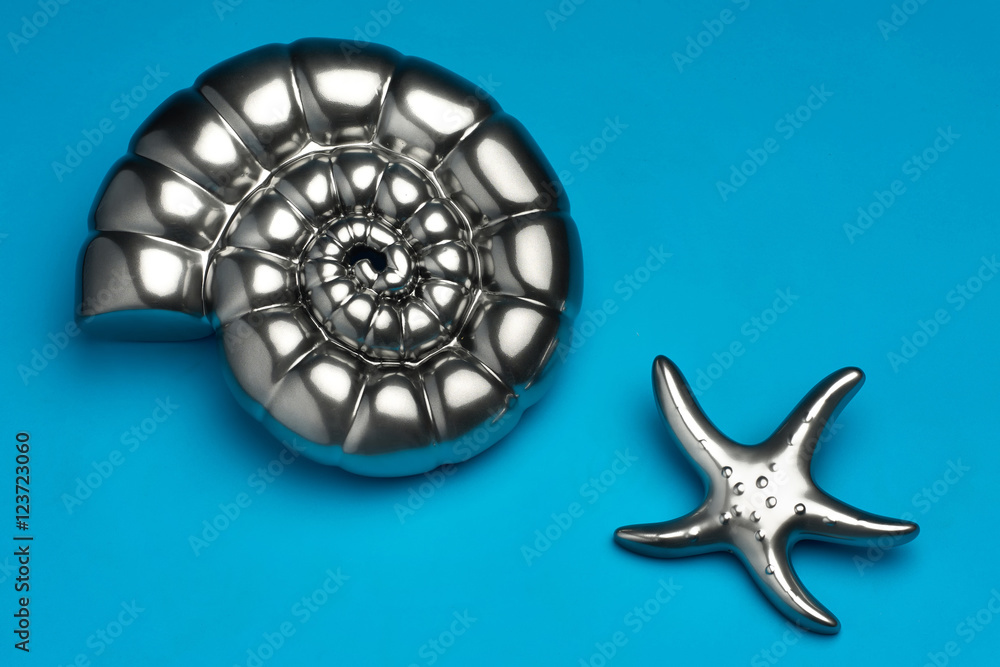 Seashell and starfish made of metal. Stock Photo | Adobe Stock