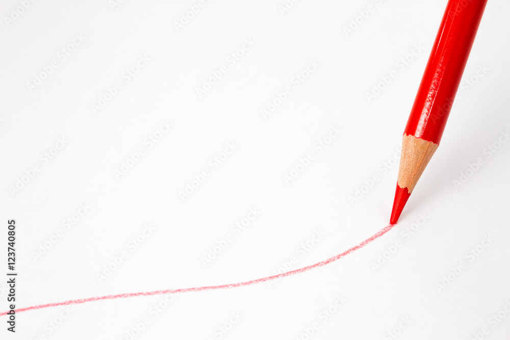 Red pencil drawing a line on a white paper Stock Photo | Adobe Stock