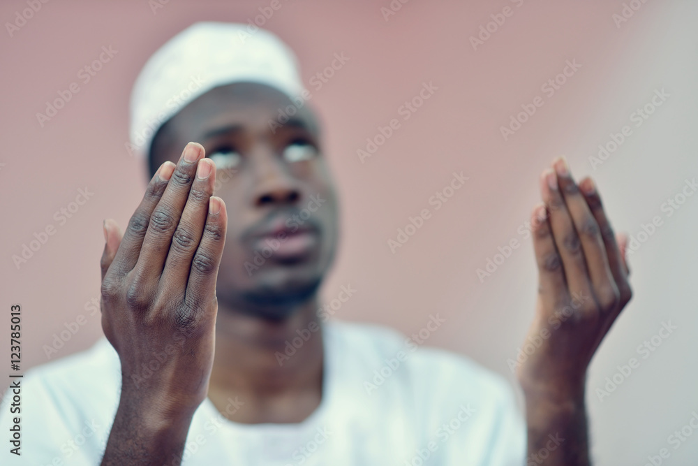 African Muslim Man Making Traditional Prayer To God While Wearing A ...