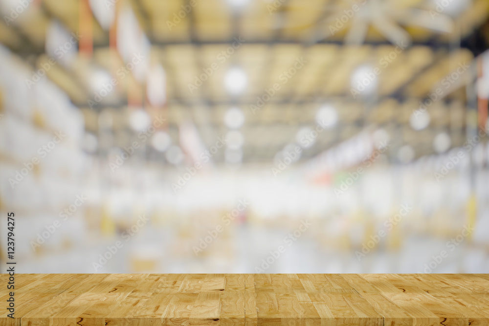 Empty wooden top table and Blurred warehouse or storehouse background ...