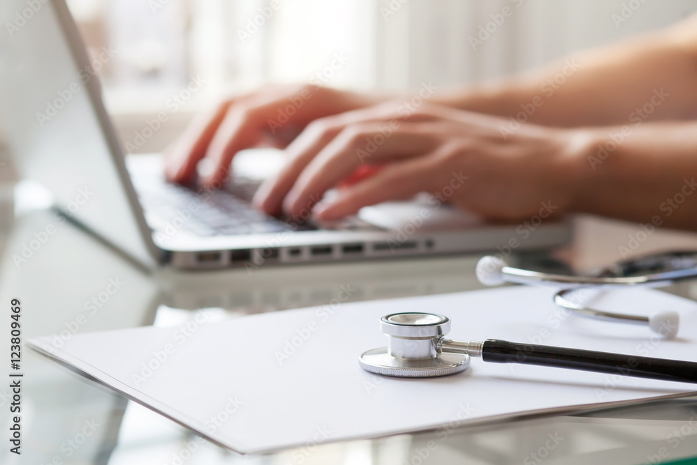 doctor working on computer, abstract medical background, focus on ...