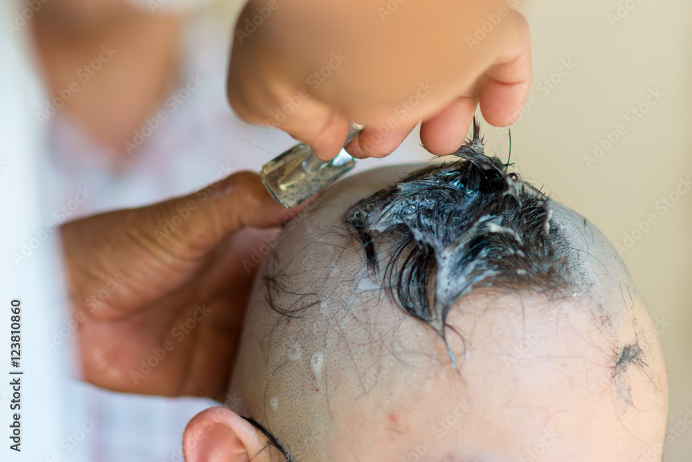 knife cutting hair at the ordination ceremony of a Buddhist monk ...