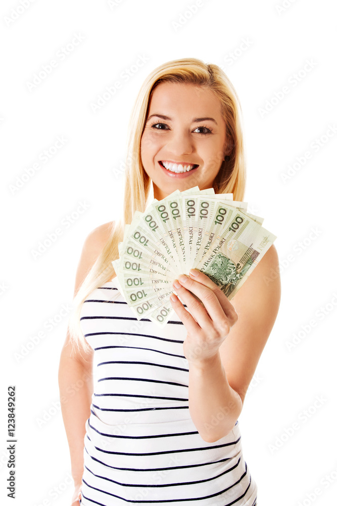 Attractive young lady holding cash and happy smiling over white ...